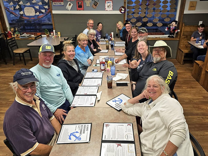 Happy diners gathered around tables prove that great food brings people together better than any social media algorithm ever could.