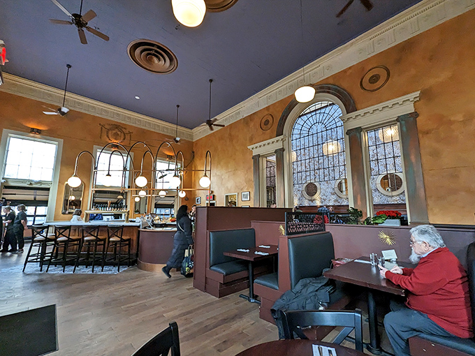 Interior Another Angle: High ceilings, globe lights, and happy diners create an atmosphere where time slows down and conversations flow freely.