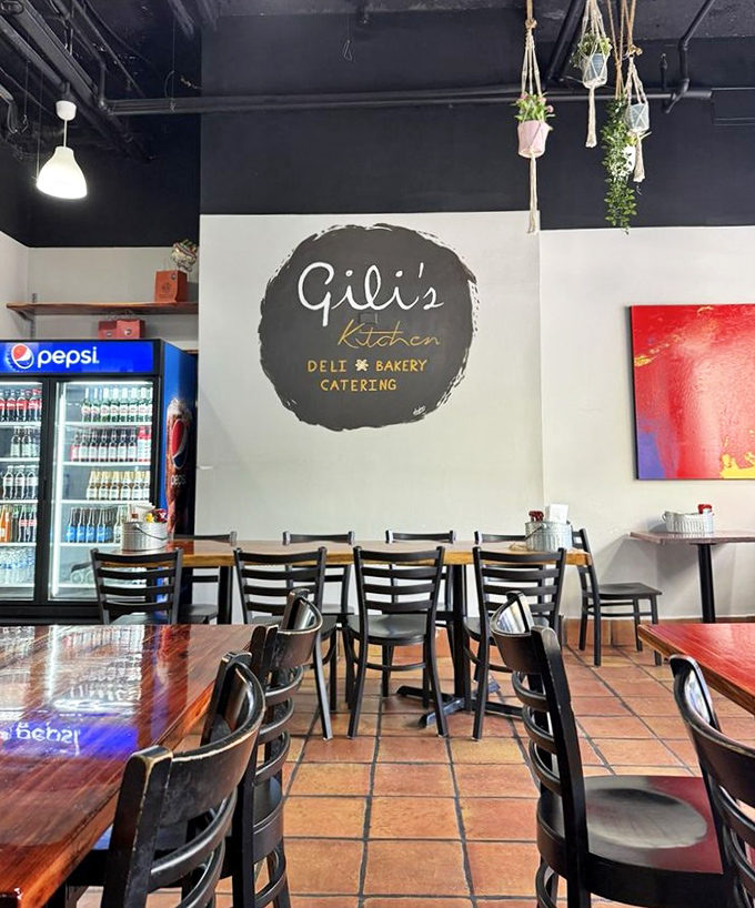 Pendant lights cast a warm glow over polished wooden tables, creating an atmosphere where lingering over coffee feels not just allowed, but encouraged.