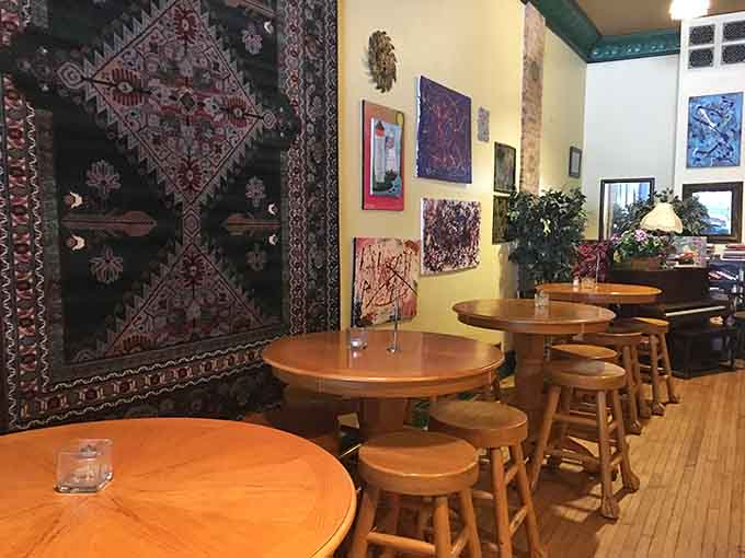 Mismatched furniture and local art create the kind of cozy atmosphere that makes you want to linger indefinitely.