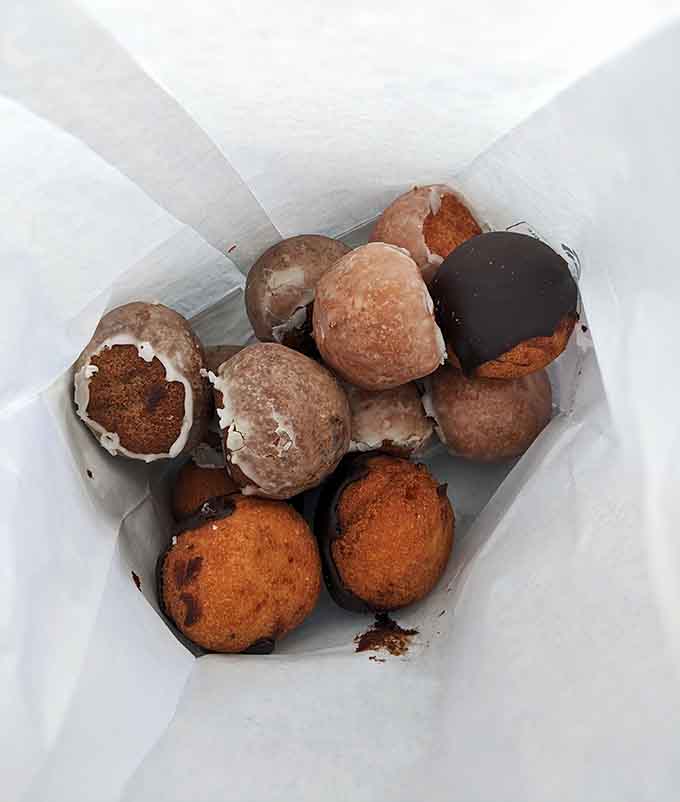 A to-go box filled with assorted treats, because sometimes you need backup donuts for later, and that's just smart planning, not a character flaw.