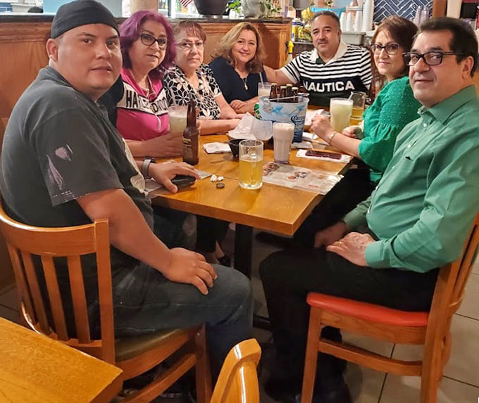The happy faces around this table tell you everything you need to know about the quality of food and warmth of hospitality here.