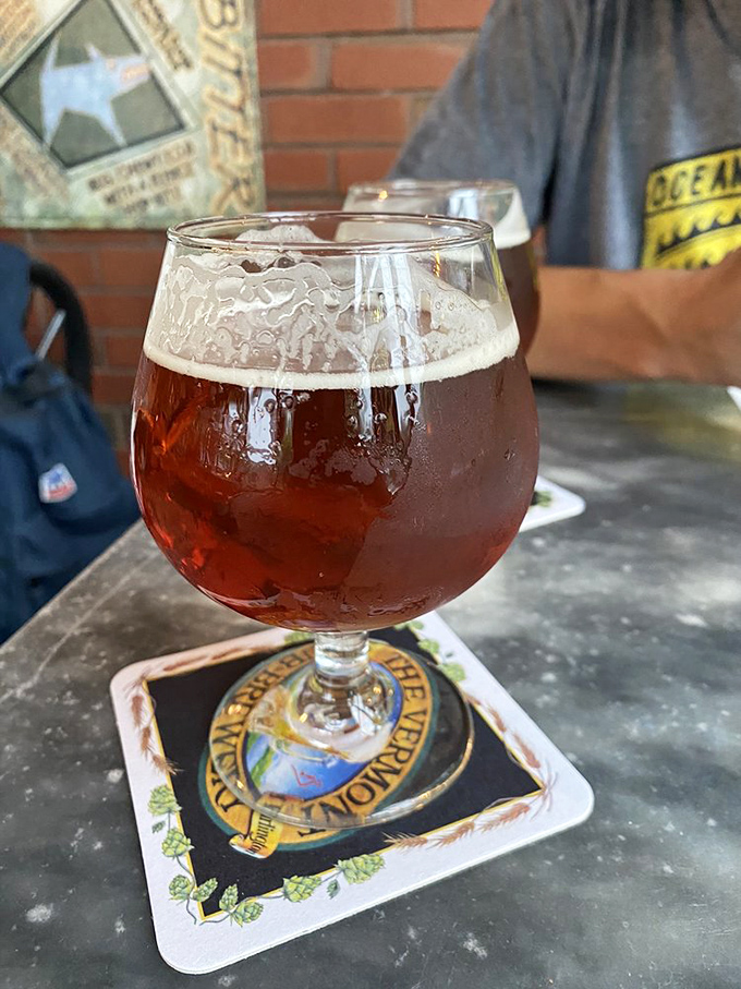 A ruby-hued beer catches the light, its perfect head retention demonstrating the brewmaster's skill in this Burlington institution.