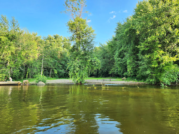 Crystal clear waters mirror the sky, creating a swimmer's paradise that's pure Vermont refreshment.
