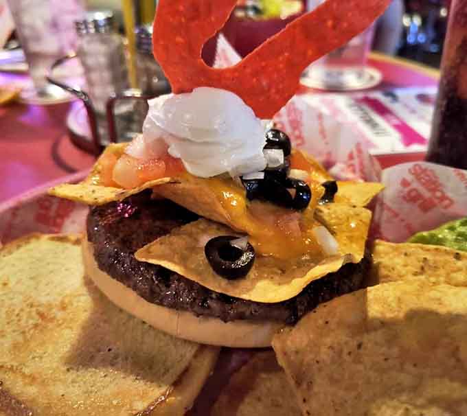 This burger construction defies gravity with its towering layers of cheese, toppings, and what appears to be a healthy dose of delicious ambition all balanced on a sturdy bun.