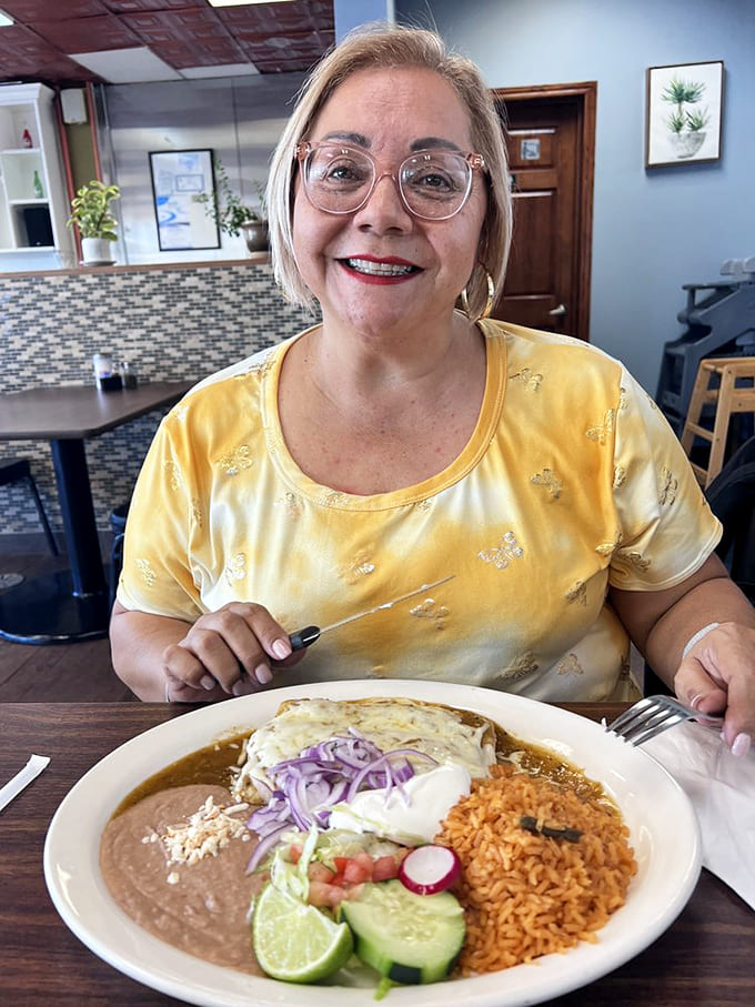 A satisfied diner enjoys a plate that's almost too pretty to eat, with rice, beans, and perfectly prepared protein creating edible harmony.