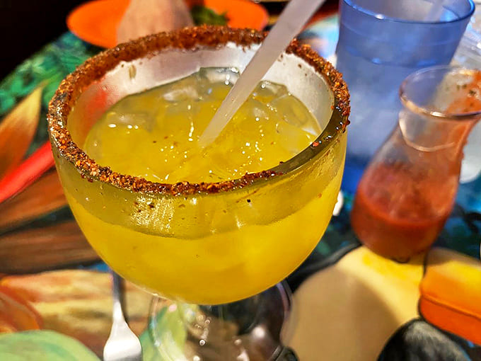 Margarita de Mango: A sunshine-yellow mango margarita with that perfect tajin rim &ndash; like a tropical vacation in glassware form.