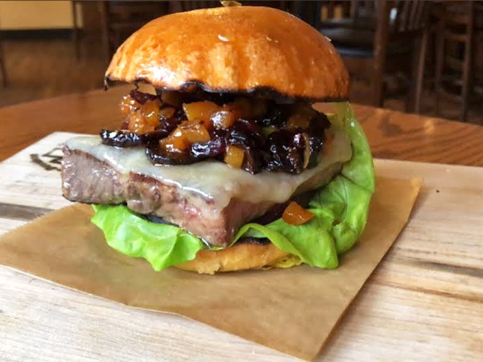 Caramelized onions cascade over melted cheese on a perfectly cooked burger &ndash; a symphony of textures waiting to be devoured.