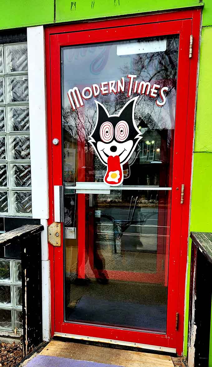 The red door beckons you inside, promising colorful surprises and satisfying meals just beyond the threshold.