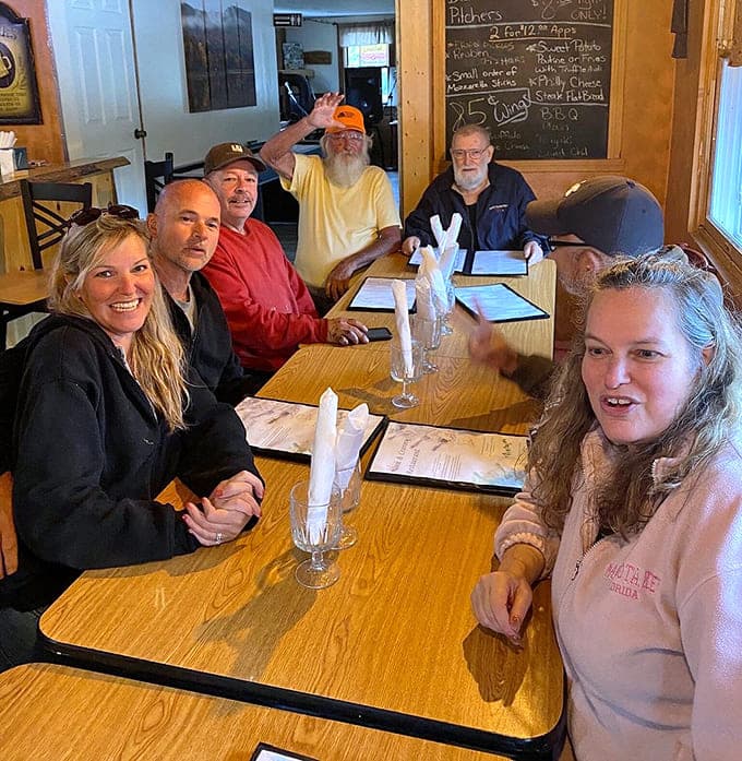 Happy diners gathered around wooden tables sharing stories and incredible food is what restaurants should be about.