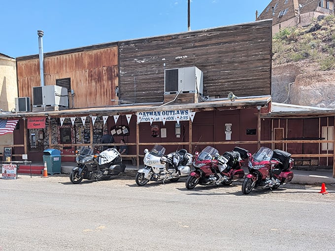 Modern road warriors park their steel horses outside establishments that once served gold miners, continuing the tradition of travelers passing through.