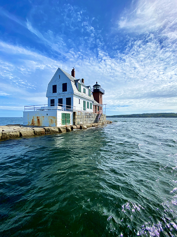 The weathered granite blocks of the breakwater have guided countless visitors toward this iconic Maine landmark for generations. 