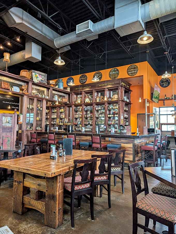 The bar area showcases an impressive whiskey collection, bottles lined up like soldiers ready to serve your evening perfectly.