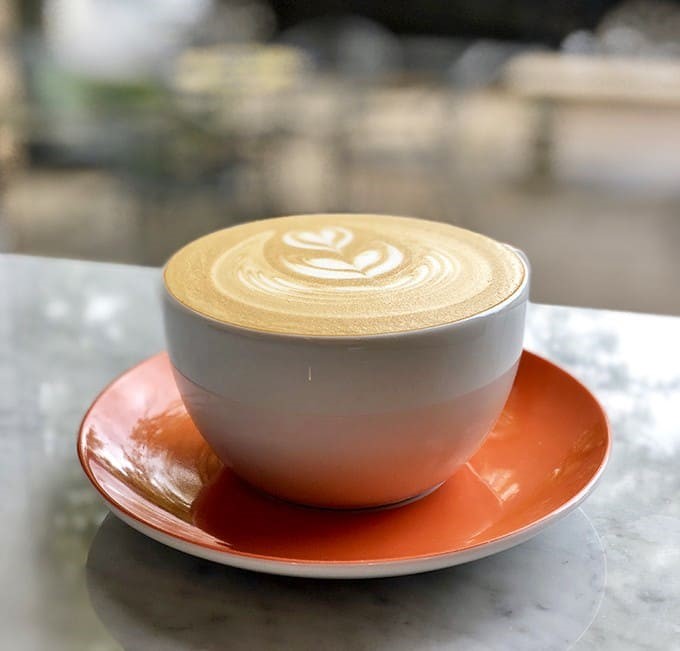 A perfectly crafted latte with foam art so pretty you almost feel guilty disrupting it &ndash; almost, but not quite.