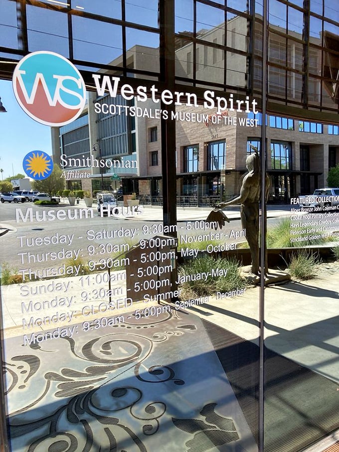 Operating hours displayed on glass doors reflect Scottsdale's modern skyline &ndash; where Old West meets New West.