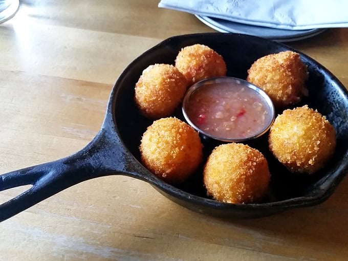 Golden-fried pimento cheese balls arrive hot and crispy, surrounding a tangy dipping sauce that cuts through the richness perfectly.