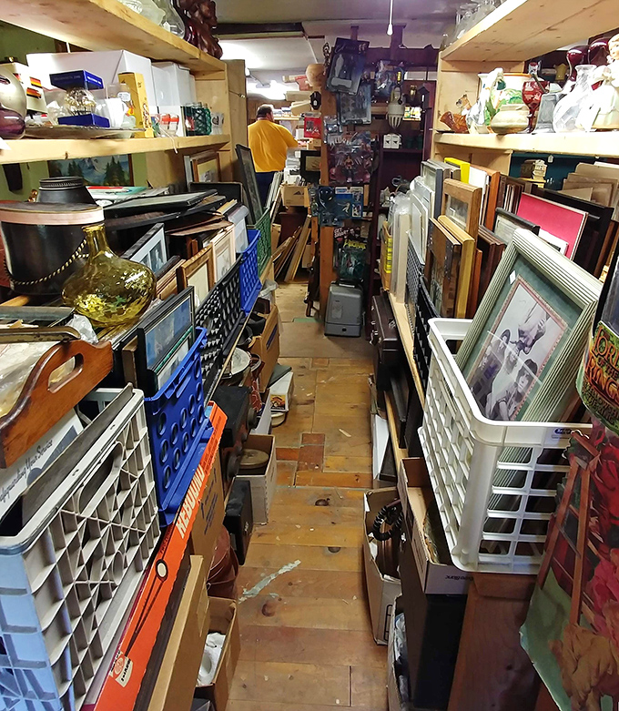 Narrow pathways between towering shelves create a treasure hunter's paradise where patience is rewarded with unexpected discoveries.