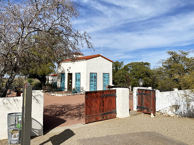 The historic Kannally Ranch House stands as a Mediterranean mirage in the Arizona wilderness, its white walls gleaming in the desert sun.