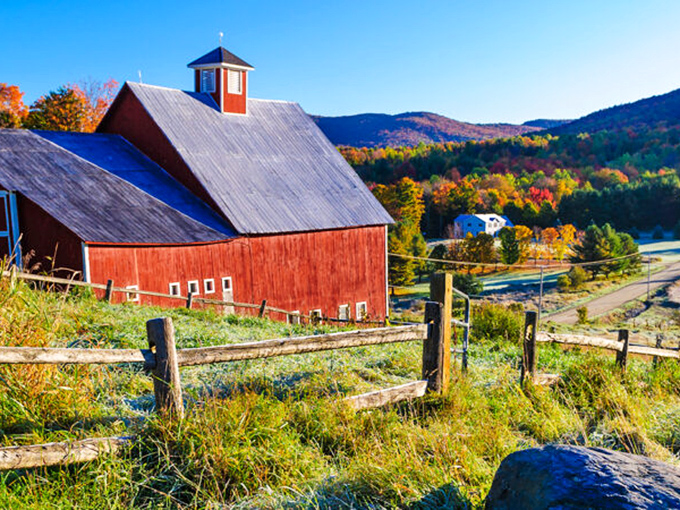 Vermont's iconic red barns pop against autumn hillsides&mdash;agricultural architecture that somehow never gets old.