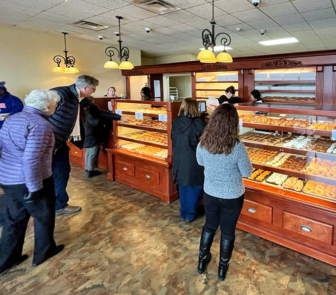 The counter where dreams come true and wallets get lighter, but nobody minds because they're leaving with armfuls of baked happiness.