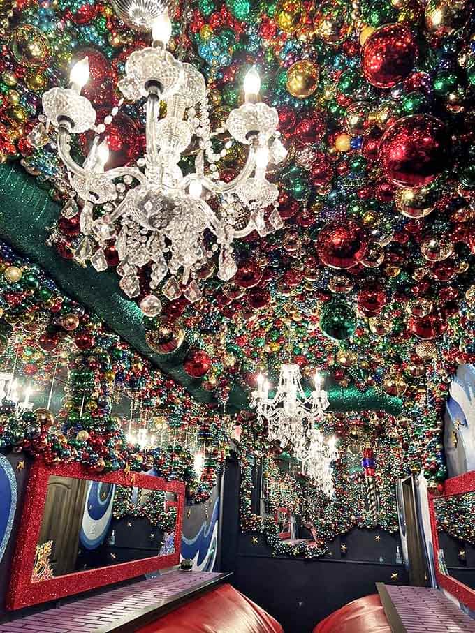 Crystal chandeliers dangle among thousands of ornaments in this breathtaking ceiling display, creating a galaxy of holiday sparkle above mesmerized visitors.