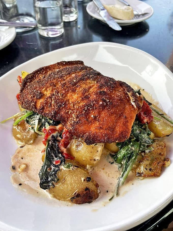 Crispy-skinned salmon nestled among seasonal vegetables&mdash;simple ingredients transformed through perfect technique and thoughtful presentation.