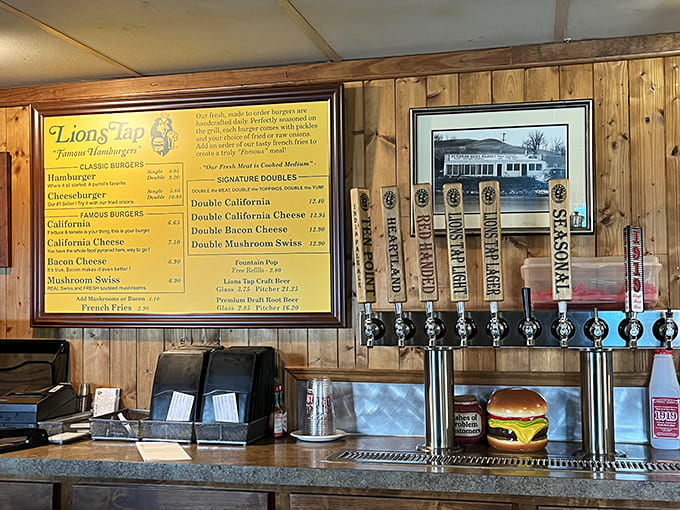 The service counter where magic happens, complete with beer taps and menu boards that promise deliciousness with every order.