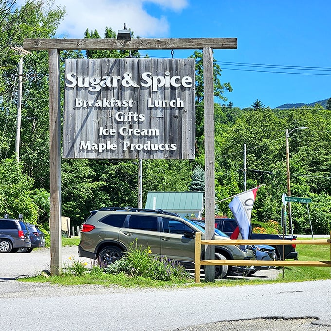 The roadside sign beckons like a maple-scented lighthouse, guiding hungry travelers to breakfast salvation amid Vermont's rolling green hills.