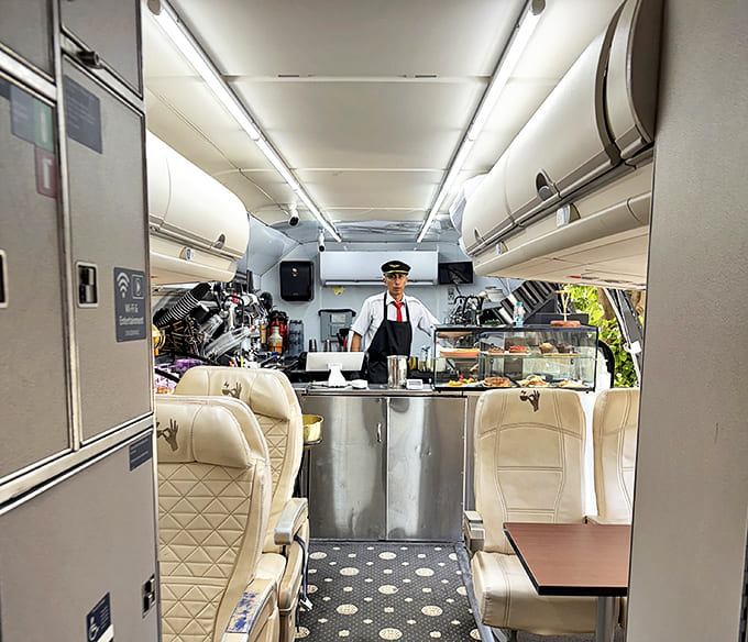 Staff in aviation-inspired attire navigate the narrow galley with the precision of seasoned flight attendants, delivering coffee excellence with a smile.