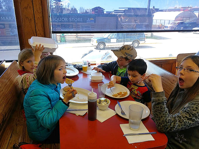 Young diners demonstrate the universal appeal of good breakfast food, their expressions capturing that moment when the plates arrive and hunger meets happiness.