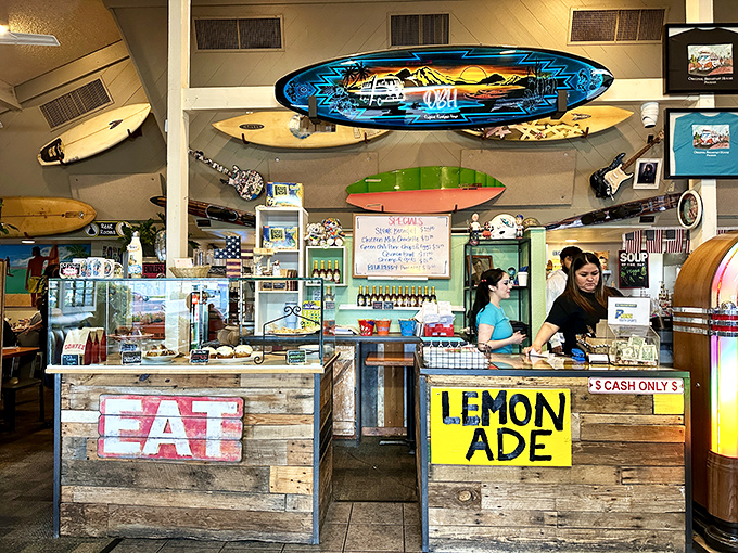 Behind the counter, colorful surfboards and cheerful signage create a playful backdrop for the serious business of breakfast perfection.