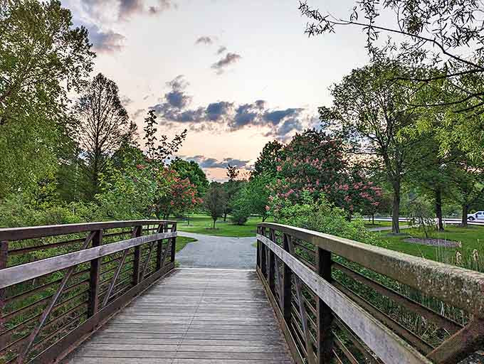 The wooden bridge at sunset creates a pathway between everyday life and moments of pure, unfiltered natural beauty.