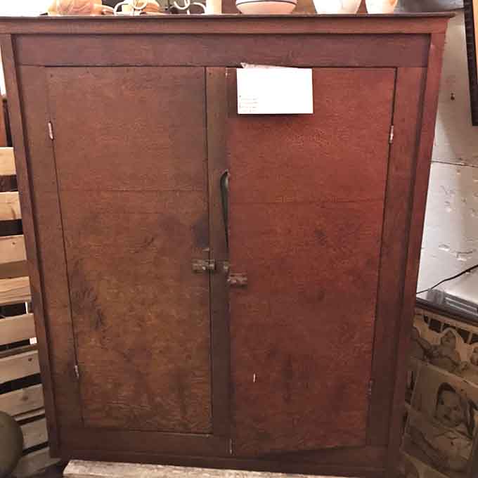 Wooden cabinets showcase craftsmanship from an era when furniture was expected to survive multiple generations and possibly an apocalypse.