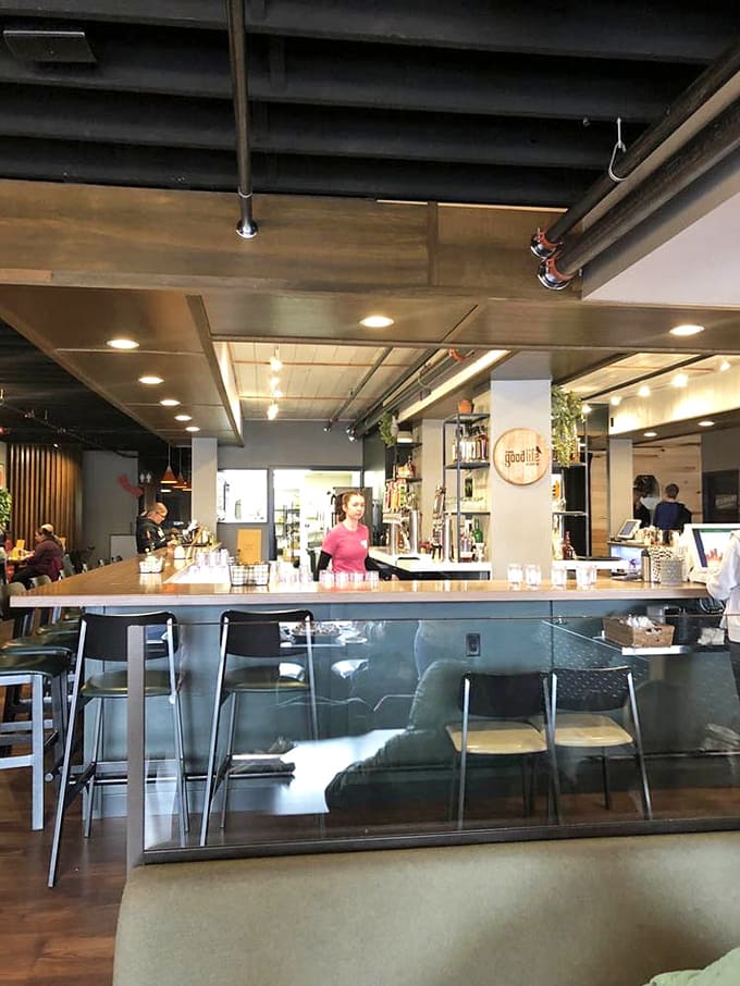 The well-stocked bar showcases an impressive tap selection and retail products, making it both functional and visually interesting.