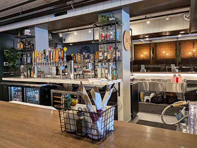 The bar area showcases an impressive tap selection, ready to pour whatever craft beer or cocktail your heart desires.