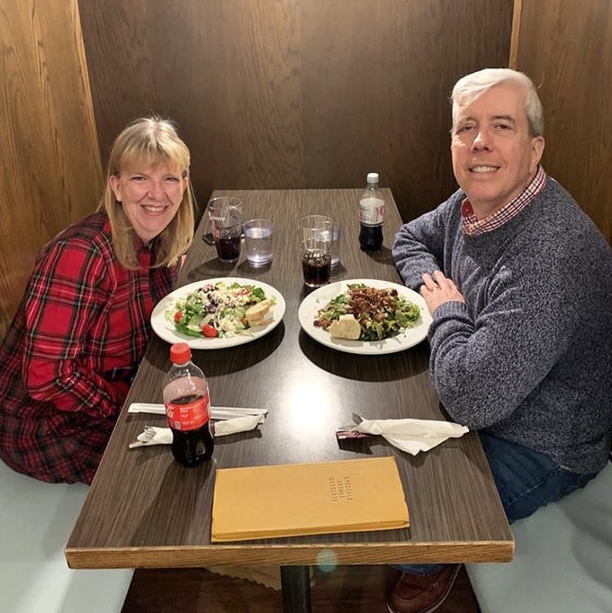 Happy diners enjoying their meals in cozy booths, living their best Good Life Cafe moment together.