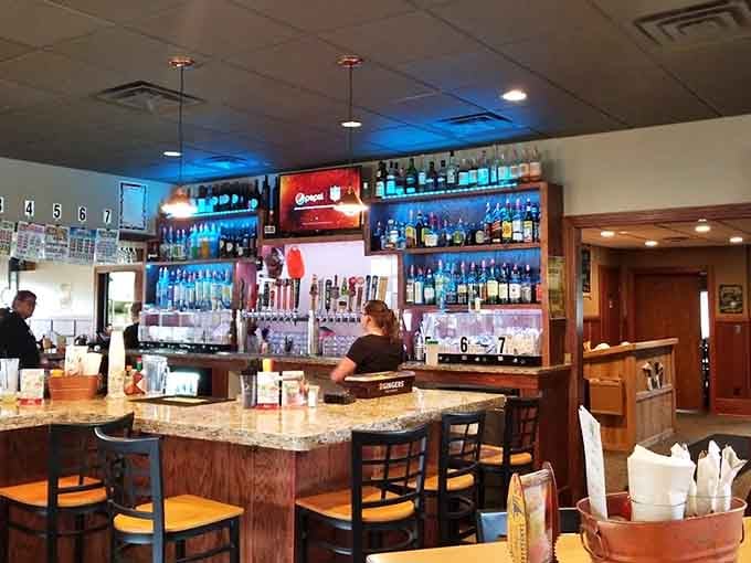 The bar area beckons with its impressive bottle selection and the promise of perfectly poured drinks from bartenders who know their stuff.