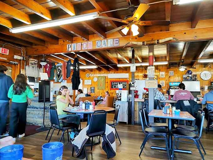 Exposed beam ceilings and wood-paneled walls create that authentic diner atmosphere where locals and travelers become temporary neighbors.