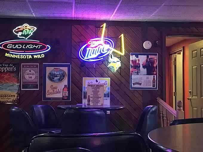 Neon signs and sports memorabilia decorate the walls, creating a classic bar atmosphere that feels both nostalgic and timeless.