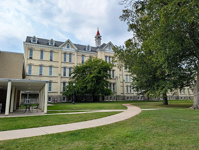 Graceful pathways wind through meticulously maintained grounds, continuing the tradition of therapeutic landscapes that was central to the hospital's philosophy.