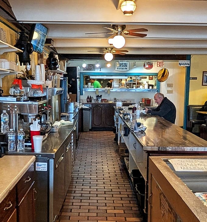 The service counter where coffee flows freely and pie dreams come true, one slice at a time for grateful customers.