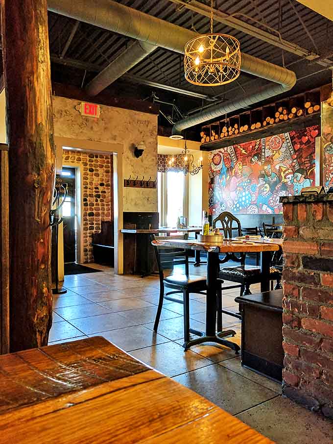 Exposed beams and warm lighting create an inviting space where lingering over that last slice feels not just acceptable but encouraged.