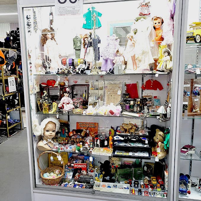 Doll display that's equal parts charming and slightly unsettling. These silent witnesses to childhood have seen it all with their unblinking eyes.