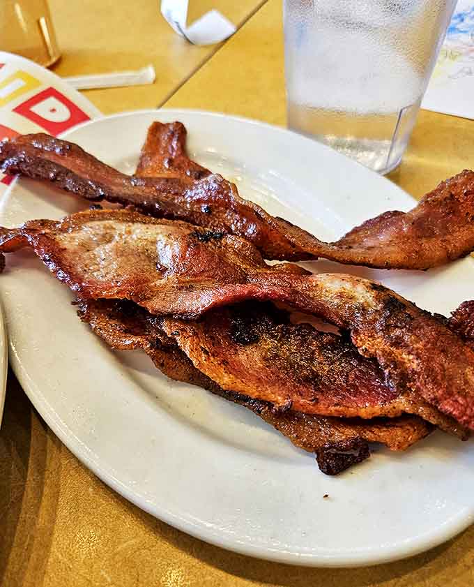 When bacon enters the burger equation, everything gets better. This crispy, savory addition transforms an already great burger into something transcendent.