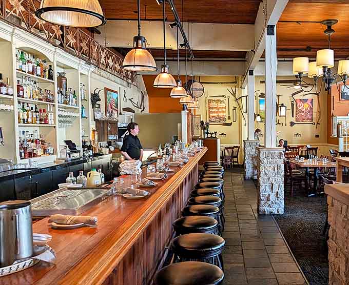 The circular bar crowned with beer badges tells stories of liquid history, while friendly bartenders create the welcoming atmosphere that defines a true public house.