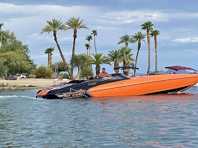 Speed demons carve wakes across the glassy surface, their vibrant vessels adding splashes of color to the blue canvas.