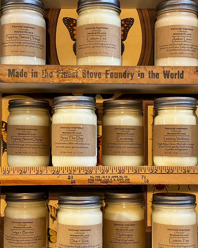 Handcrafted candles in mason jars offer scents inspired by nature and nostalgia, each one labeled with evocative names like "Cotton+Tea."