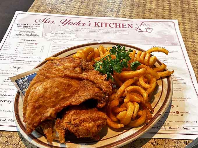 Crispy fried chicken paired with curly fries &ndash; proof that sometimes the simplest combinations deliver the most profound satisfaction.