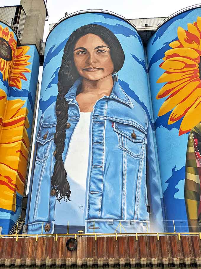 A portrait emerges from the concrete canvas, bringing human warmth and cultural heritage to what was once cold industrial infrastructure.