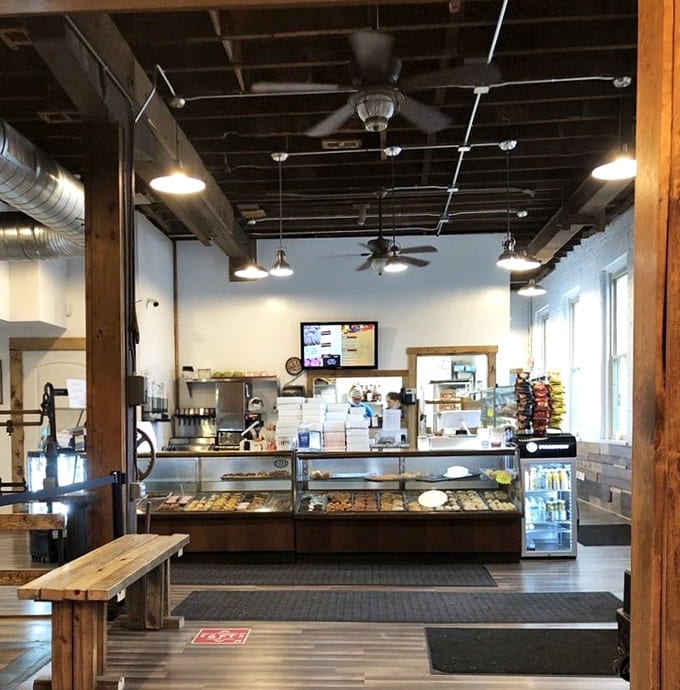 A cozy fireplace corner invites customers to linger over coffee and pastries, proving that New System is as much community living room as it is bakery.